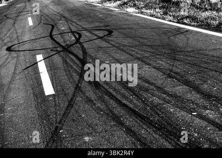 Background with tire marks on road closeup photo Stock Photo - Alamy