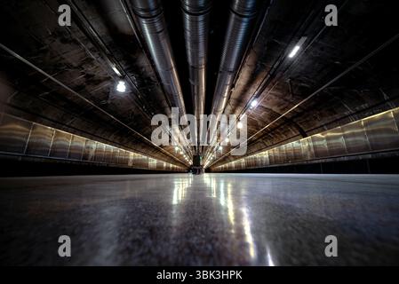 Underground tunnel for the subway leading deep down Stock Photo - Alamy