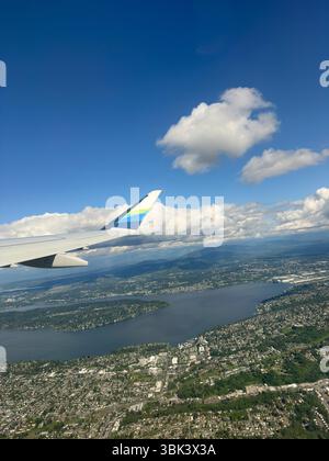 Seattle, USA - 12 MAY 2025 - A Plane taking off over properties and ...