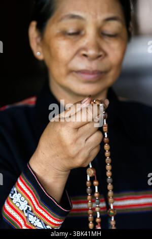 Bahnar woman from ethnic minorities praying the rosary in church ...