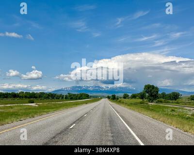 Open fields and majestic mountains in the background. Rural countryside ...
