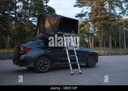 Modern SUV with Foldable Rooftop Tent in a Forest Setting Stock Photo ...