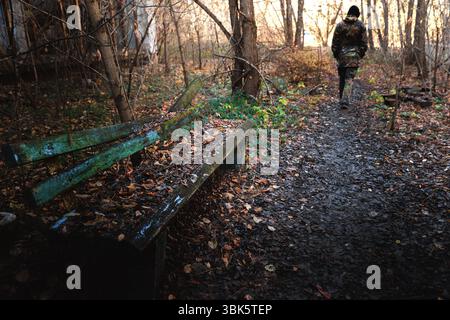 Old destroyed bench next to path angle shot Stock Photo - Alamy