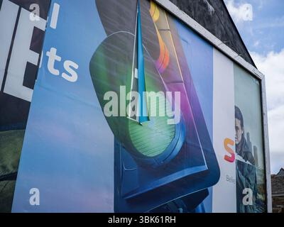 Peeling billboard on gable end of building Camborne Town Cornwall Stock ...