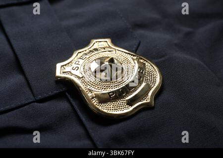 Police badge on dark blue uniform, above view Stock Photo - Alamy