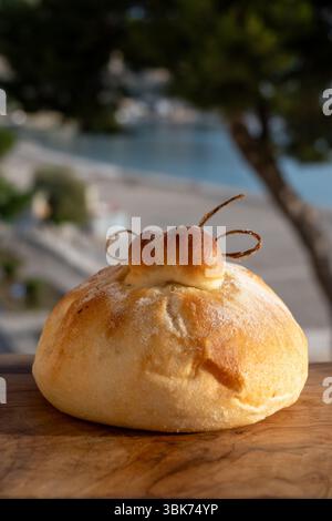 Fresh baked bread in burrata cheese shape filled with tomatoes ...