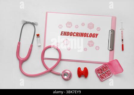 Endocrinology. Stethoscope and model of thyroid gland on light blue ...