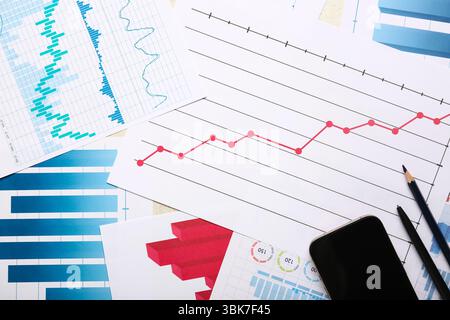 Mobile phone with stationery, many business documents and graphics on ...