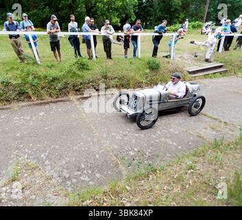 Tim Holdsworth's CycleKart, based on 1934, E.R.A, in formation down the finishing straight ...