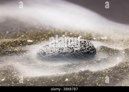 Smoke whirling around small meteorite stone closeup footage Stock Photo ...