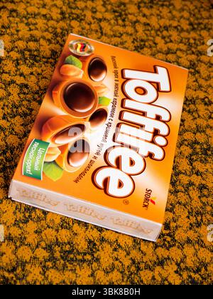 Box of Toffifee hazelnut and caramel candy cups topped with chocolate ...