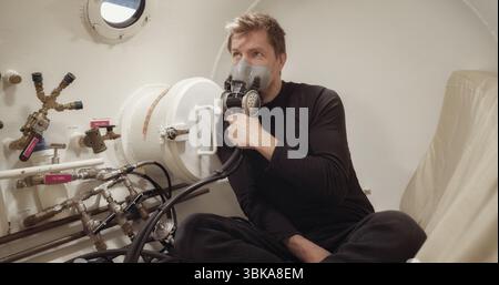 Man receiving treatment in the hyperbaric chamber in a clinic Stock ...