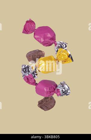 colored candies on yellow background Stock Photo - Alamy