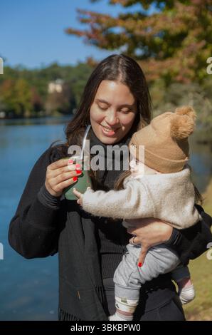 Cute baby trying to drink his mother's chimarrão (mate Stock Photo - Alamy