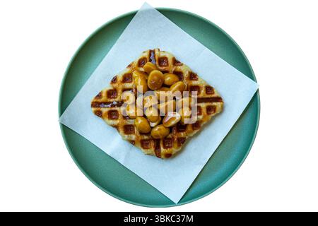 Macadamia caramel cake topping with macadamia nuts with coffee on table ...
