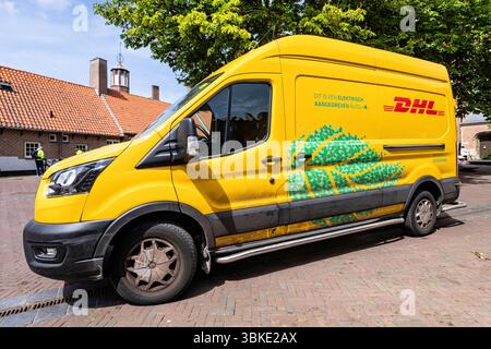 Yellow dhl ford transit courier electric delivery van driving on a road ...
