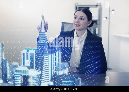 Building information modelling. Woman using holographic projection of ...