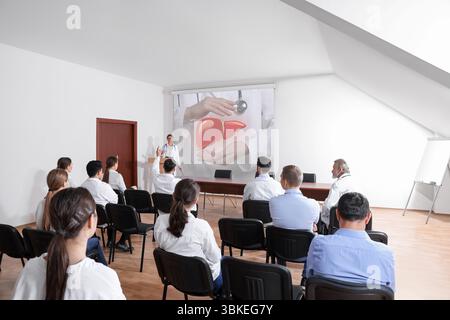 Healthcare professional giving lecture about liver in conference room ...