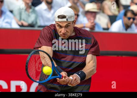 Jack Draper, of United States, returns a shot during a mixed doubles ...