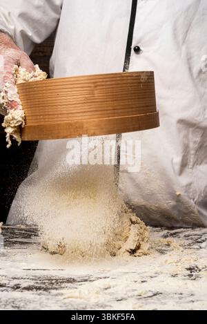 Dough on white powder covered table. Hand flour. Hands baker with flour ...