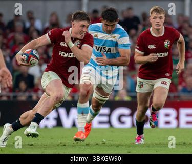 Tommy Freeman of the British & Irish Lions, right, is tackled by ...