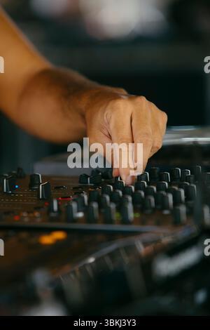 Close up view of a dj's hands playing the mixer while performing Stock ...