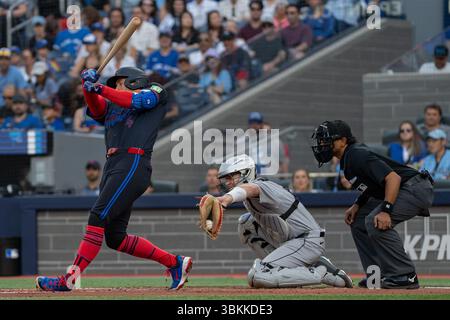 Toronto Blue Jays' George Springer, left, is greeted by Addison Barger ...