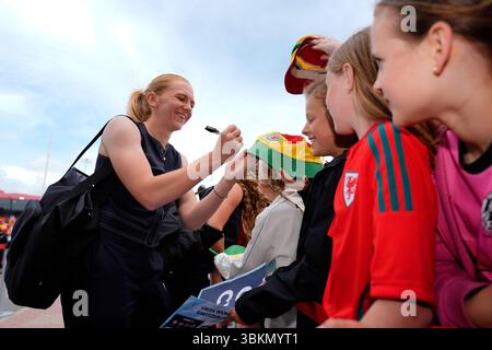 Wales' Ceri Holland signs a young fans hat at Cardiff Airport. Picture ...