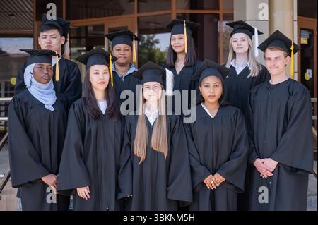 Multinational students in graduation gowns Stock Photo - Alamy