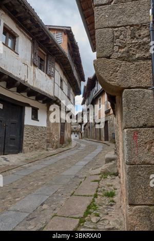 Cobbled alley in La Alberca flanked by traditional stone and half ...