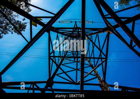 steel beams make up the intricate geometries of a high voltage pylon ...