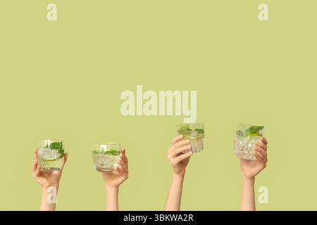 Female hands with different glasses of mojito on green background Stock ...