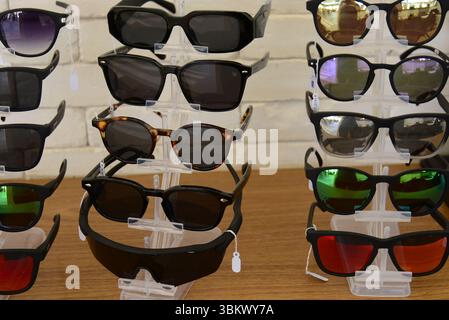 Sunglasses on display. a collection of sunglasses on a table top Stock ...