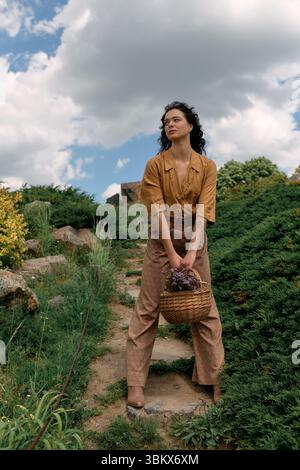 Woman in summer clothes enjoys riding a horse on a beautiful sandy ...