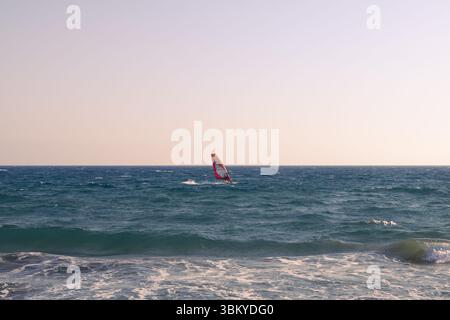 Limassol, Cyprus, 06-20-2025. A young man doing kite surfing on the ...