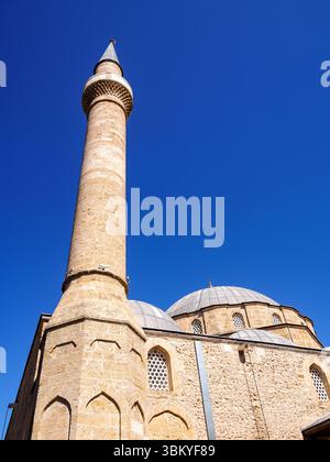 A low angle shot of a minaret against a cloudless blue sky Stock Photo ...