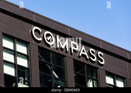 The Compass Real Estate logo on a brick office building in downtown ...