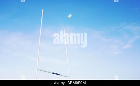 Rugby ball flying between posts Stock Photo - Alamy