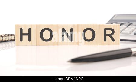 The HONOR concept word is assembled from wooden cubes. ethics, respect ...
