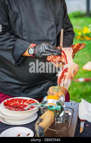 Jamon Display at Outdoor Event. Whole leg of Spanish jamon set in ...