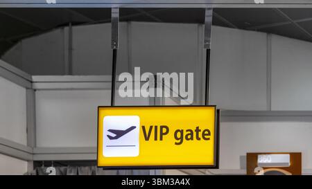 Illuminated Vip Gate Yellow Sign Hanging from Ceiling at Airport Stock ...