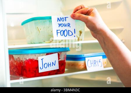 Office fridge with angry Do Not Touch My Food sticker on meal ...