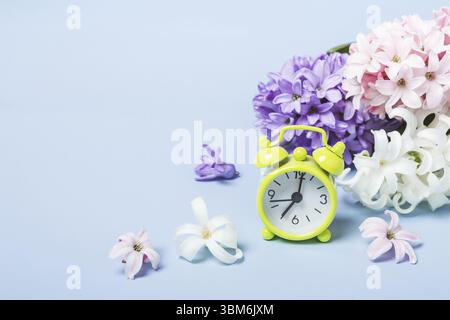 Spring Flowers Hyacinths and alarm clock. Springtime concept Stock ...