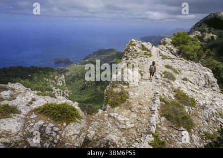 middle-aged woman walking Camí de s'Arxiduc route, Valldemossa, Majorca ...