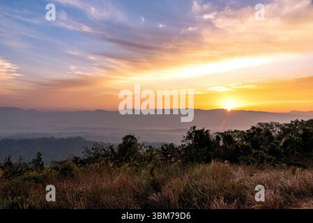A breathtaking golden sunrise or sunset casts long shadows across a ...