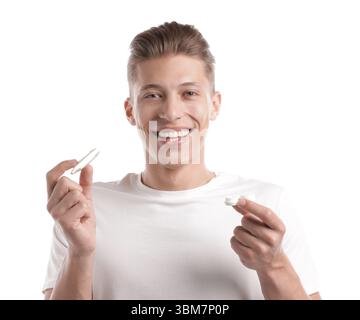 Young man with contact lenses and tweezers on color background Stock ...