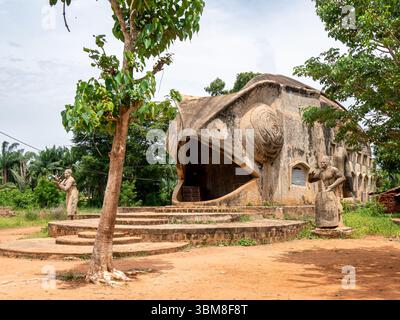 Chameleon-shaped Vodun temple near Abomey, Benin, on a cloudy afternoon ...