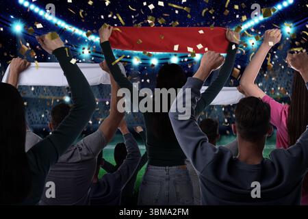 Excited fans celebrating victory in spectator area under falling ...
