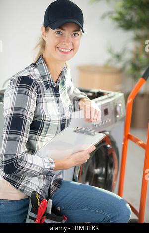 young woman delivering a washing machine Stock Photo - Alamy