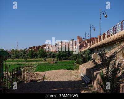 Sunlit adobe buildings with a clear blue sky in a narrow alleyway ...